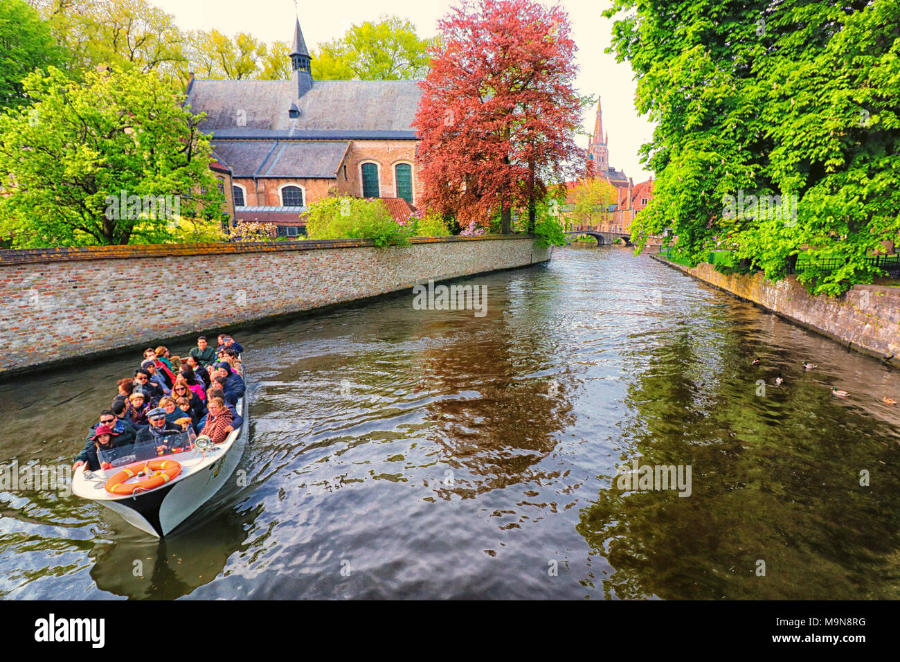 Taking a boat ride on a canal through Bruges City Centre Stock Photo ...
