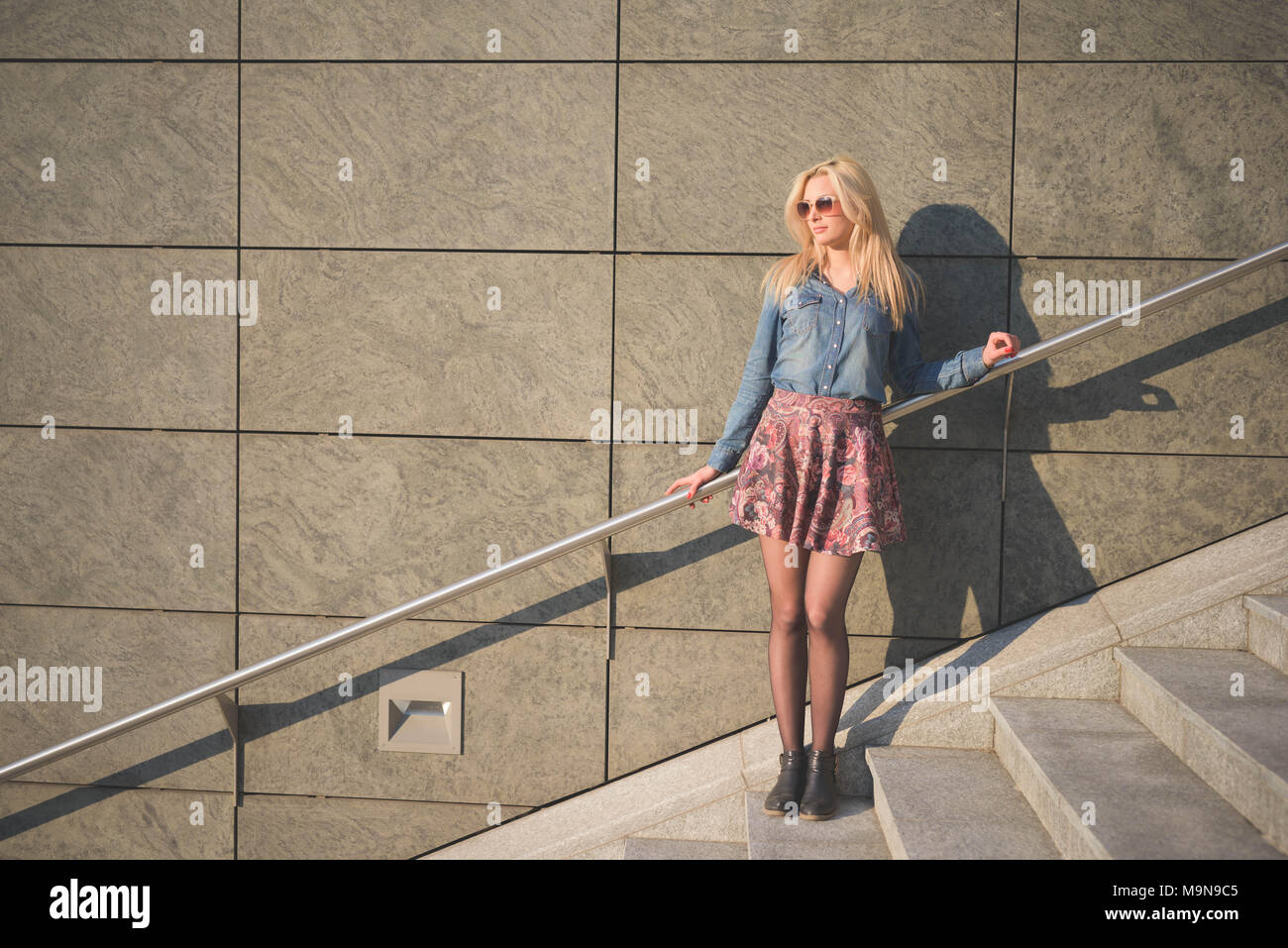 Beautiful blonde girl hiding behind hi-res stock photography and images ...