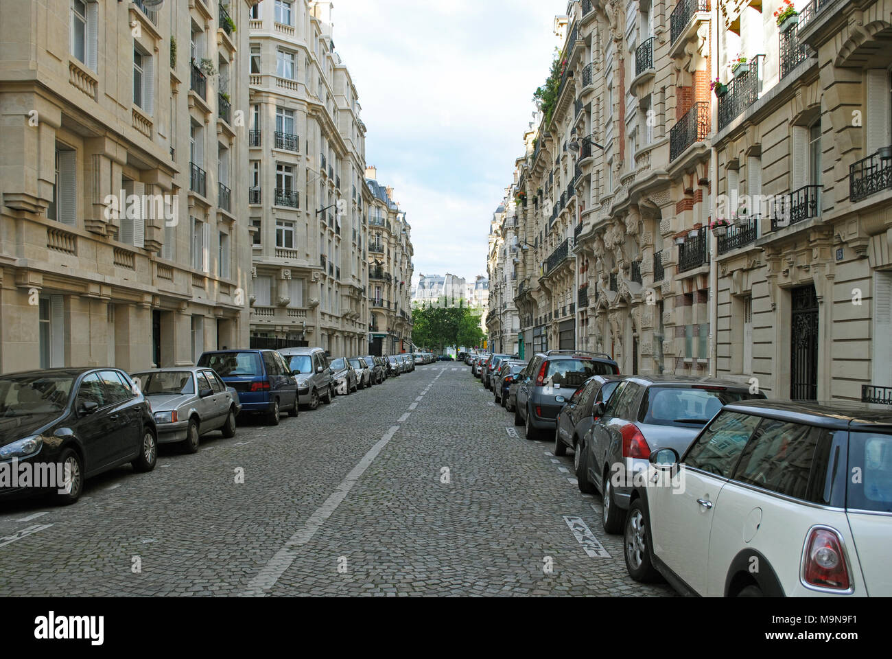 One of the many streets in the city of Paris, with a roadway paved with ...