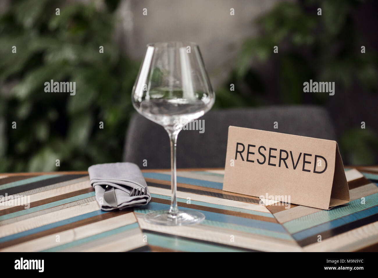 Reserved table with empty glass and cutlery in the cafe Stock Photo - Alamy
