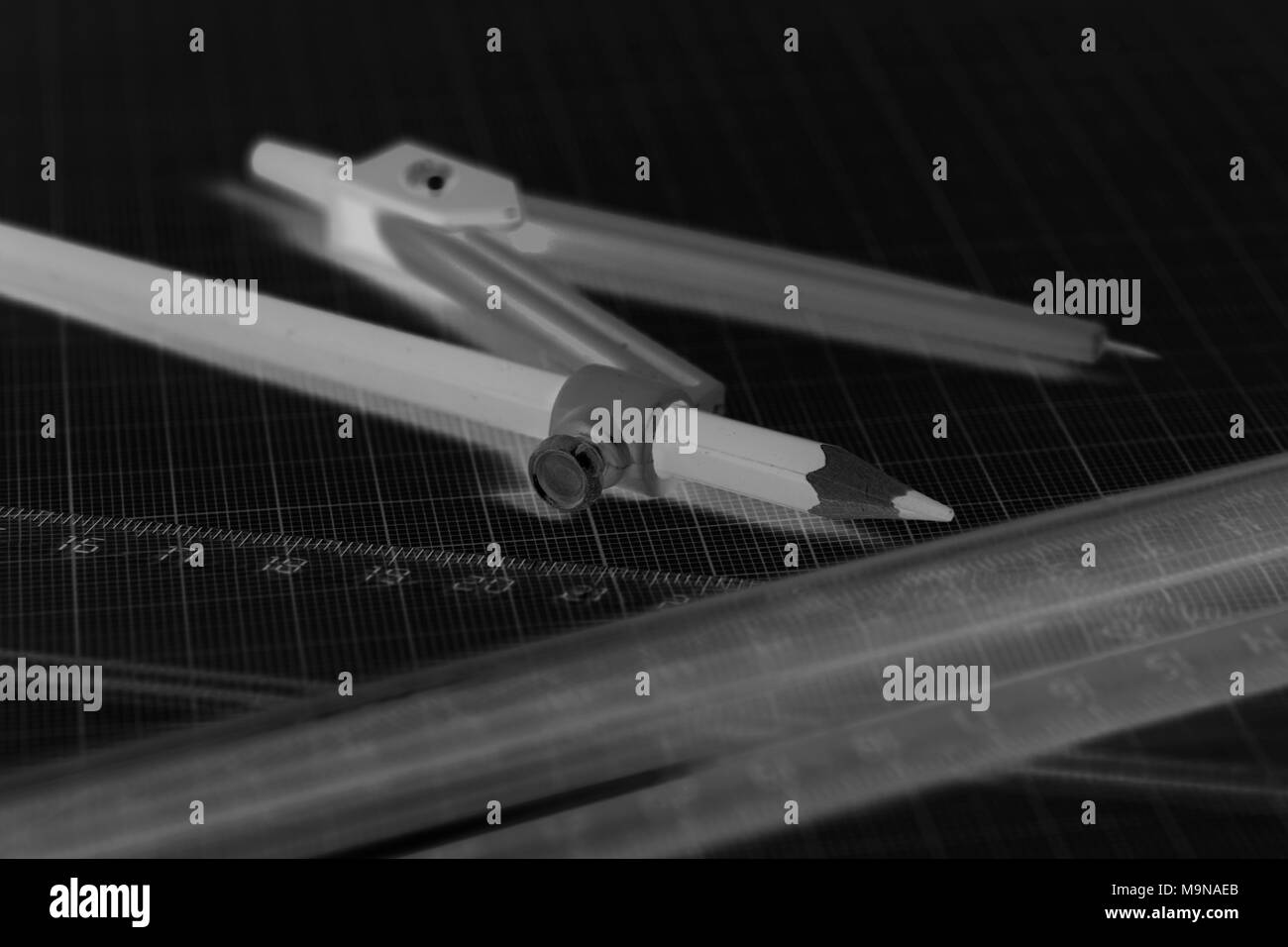 Drawing compass with black pensil and rulers on graph paper.Engineering ...