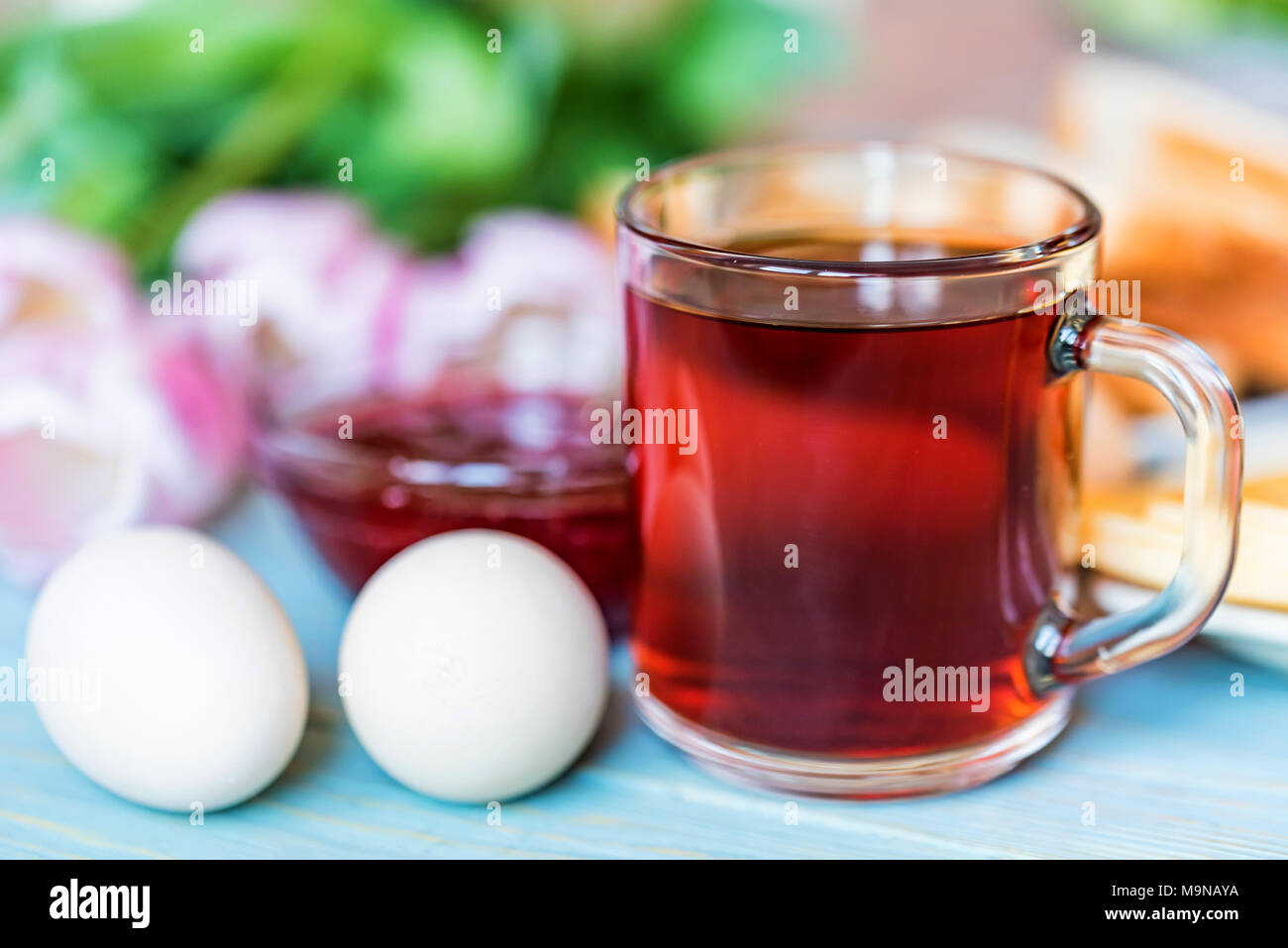 Breakfast with tea, jam and flowers Stock Photo - Alamy