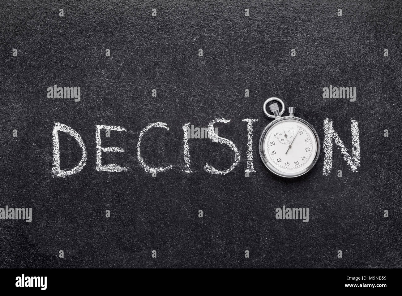decision word handwritten on chalkboard with vintage precise stopwatch ...