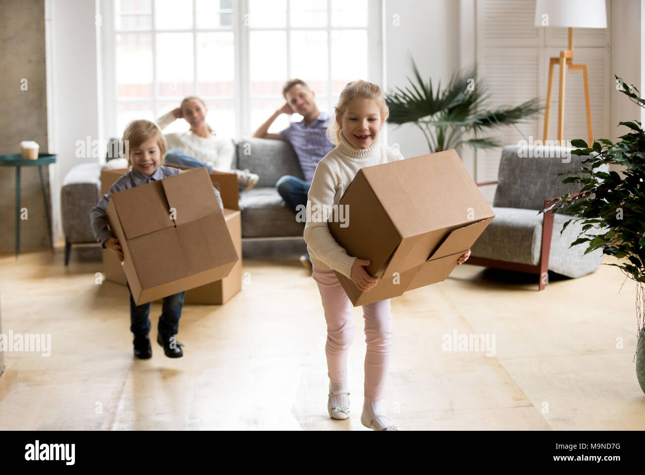 Children carrying boxes hi-res stock photography and images - Alamy