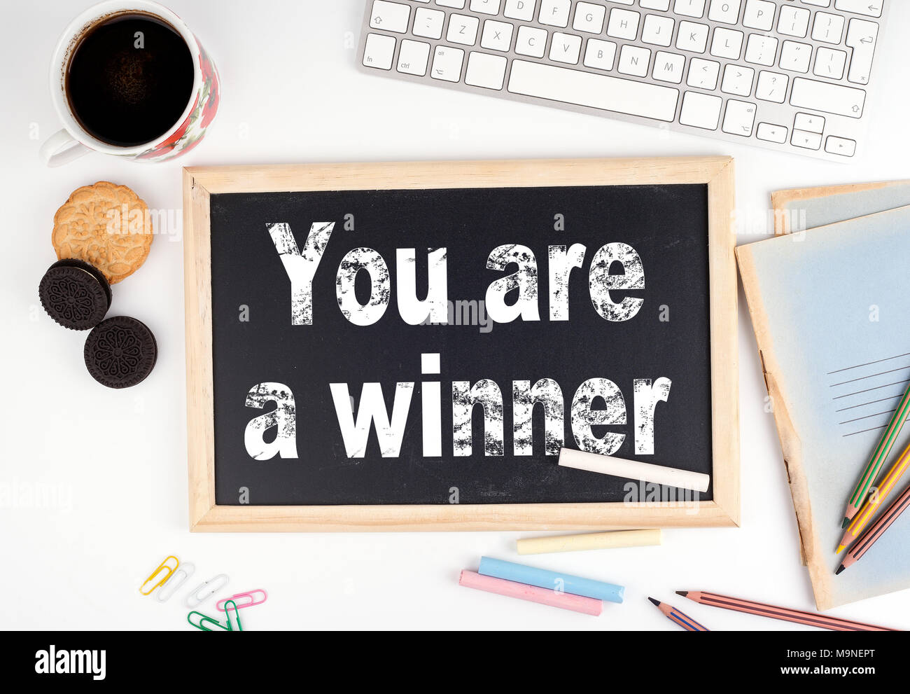 You are a winner. Chalkboard on white office desk Stock Photo - Alamy