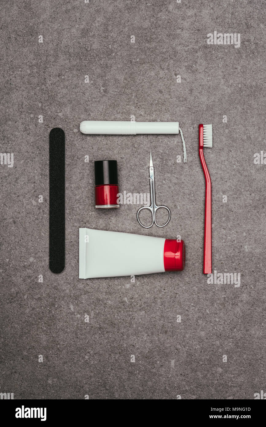 top view of arrangement of various feminine hygiene supplies on grey ...