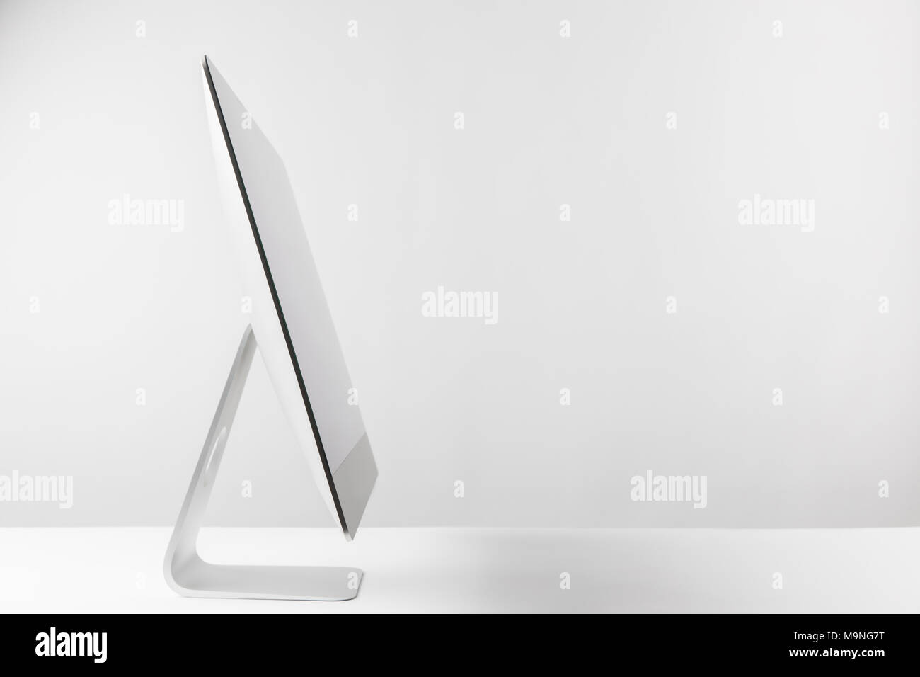 side view of desktop computer monitor on white Stock Photo - Alamy