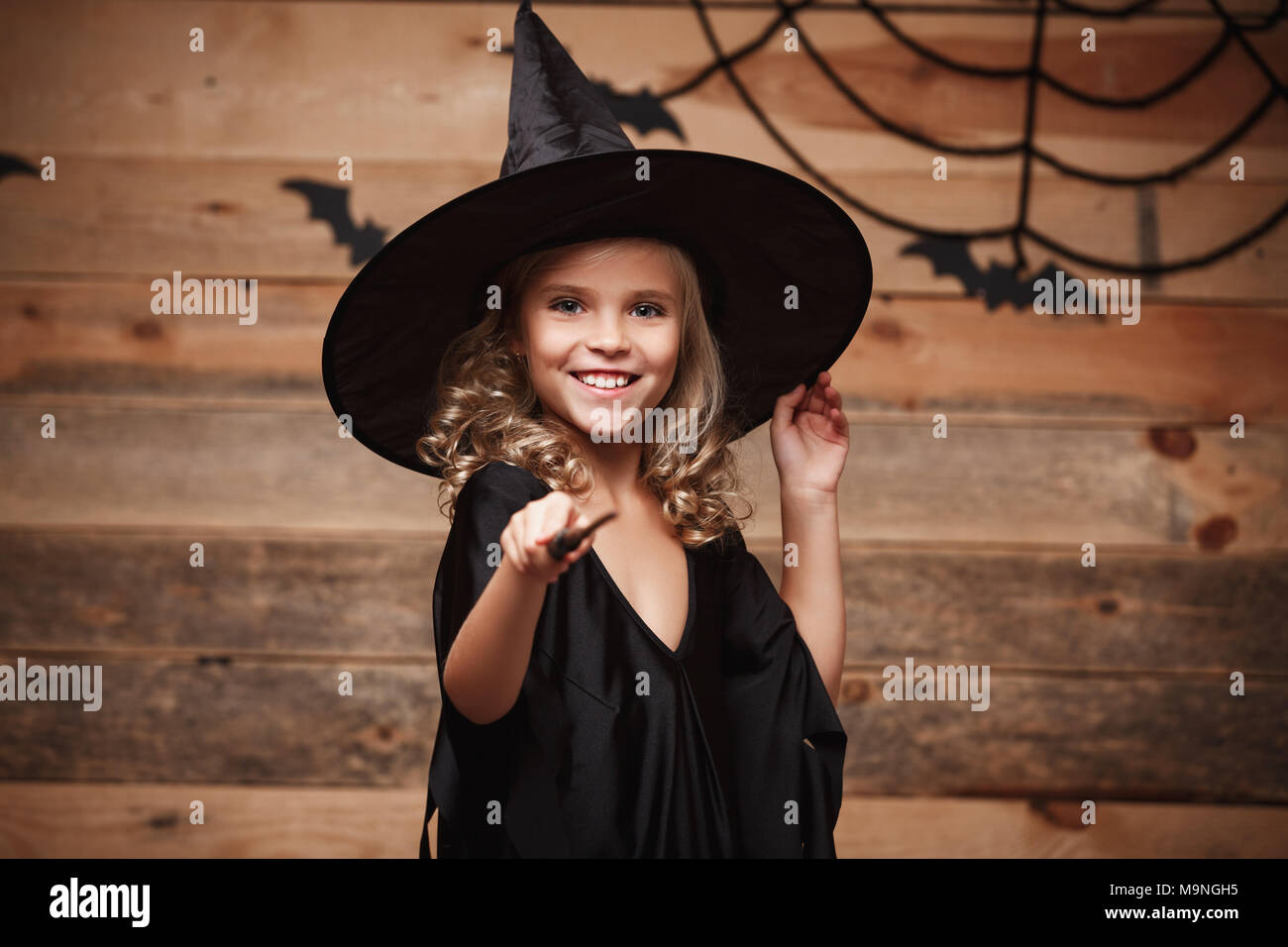 Halloween Witch concept - little witch child enjoy playing with magic ...
