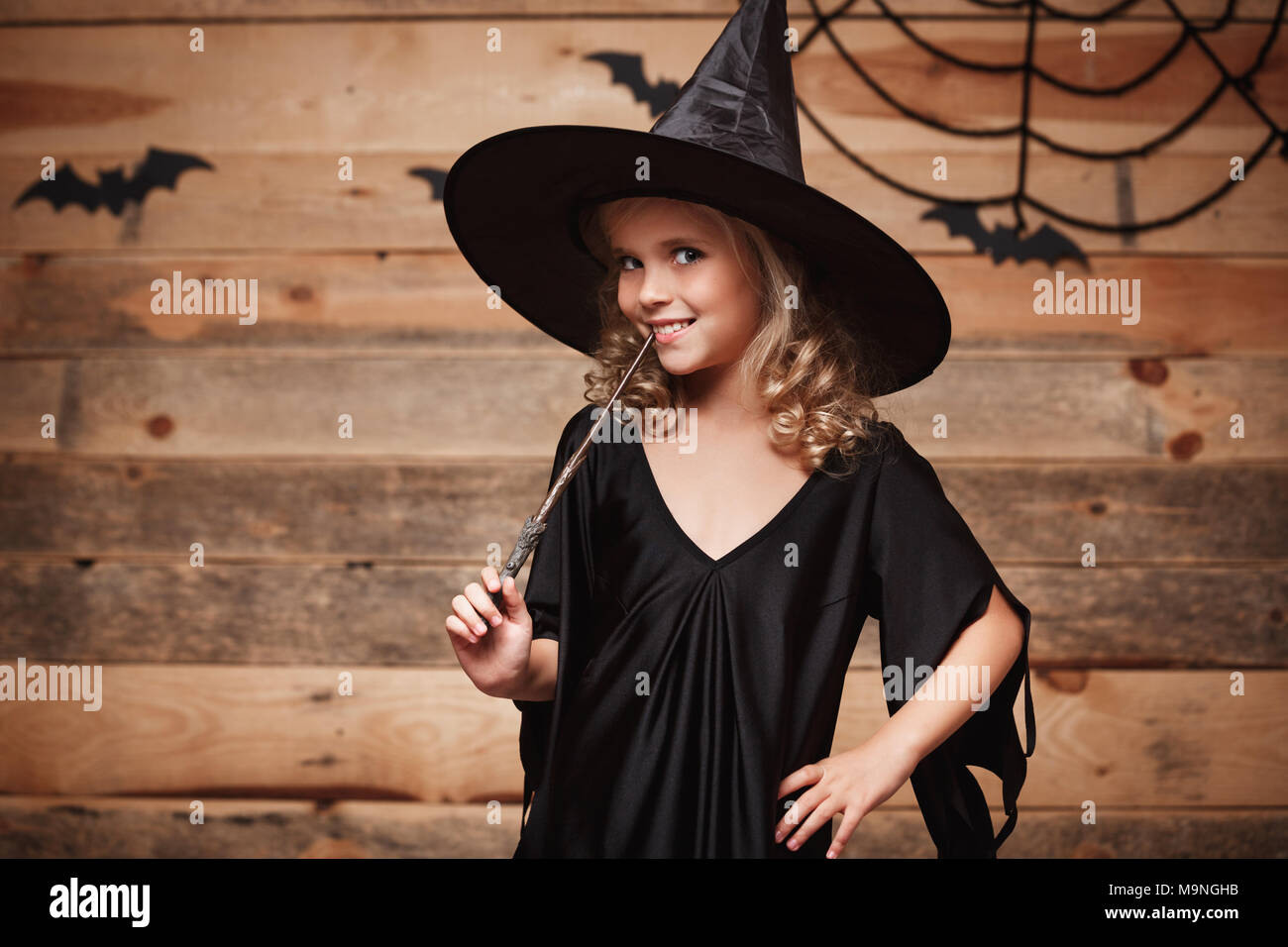 Halloween Witch concept - little witch child enjoy playing with magic ...