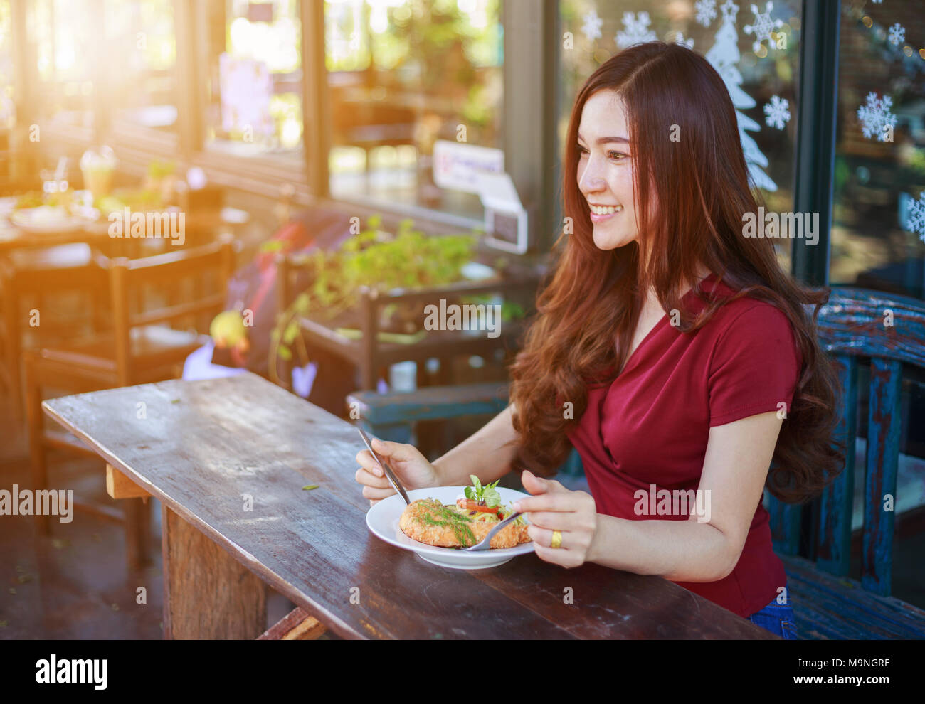 young woman eating food in a restaurant Stock Photo - Alamy