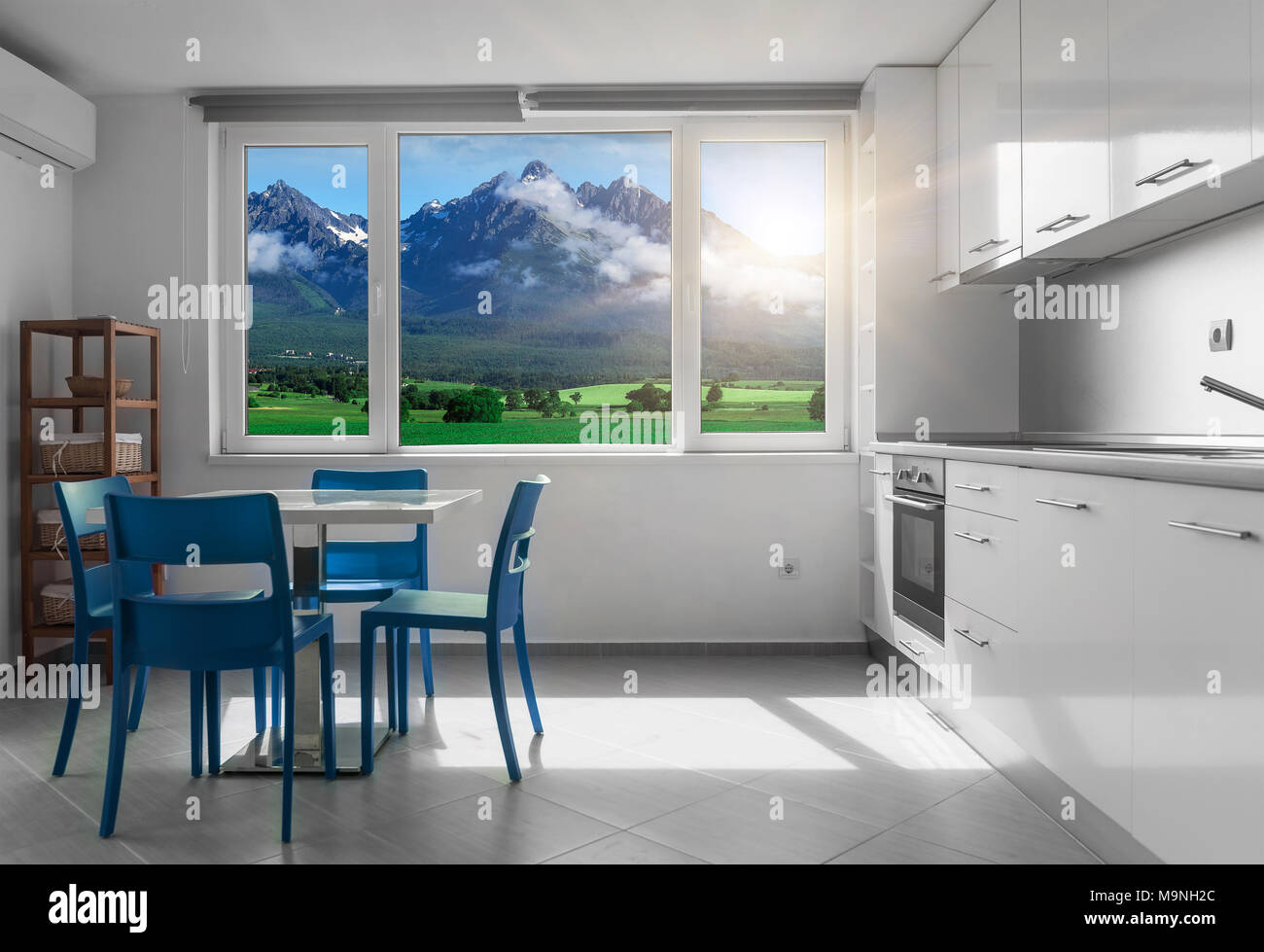 Kitchen with white furniture and windows with mountain scenery Stock ...