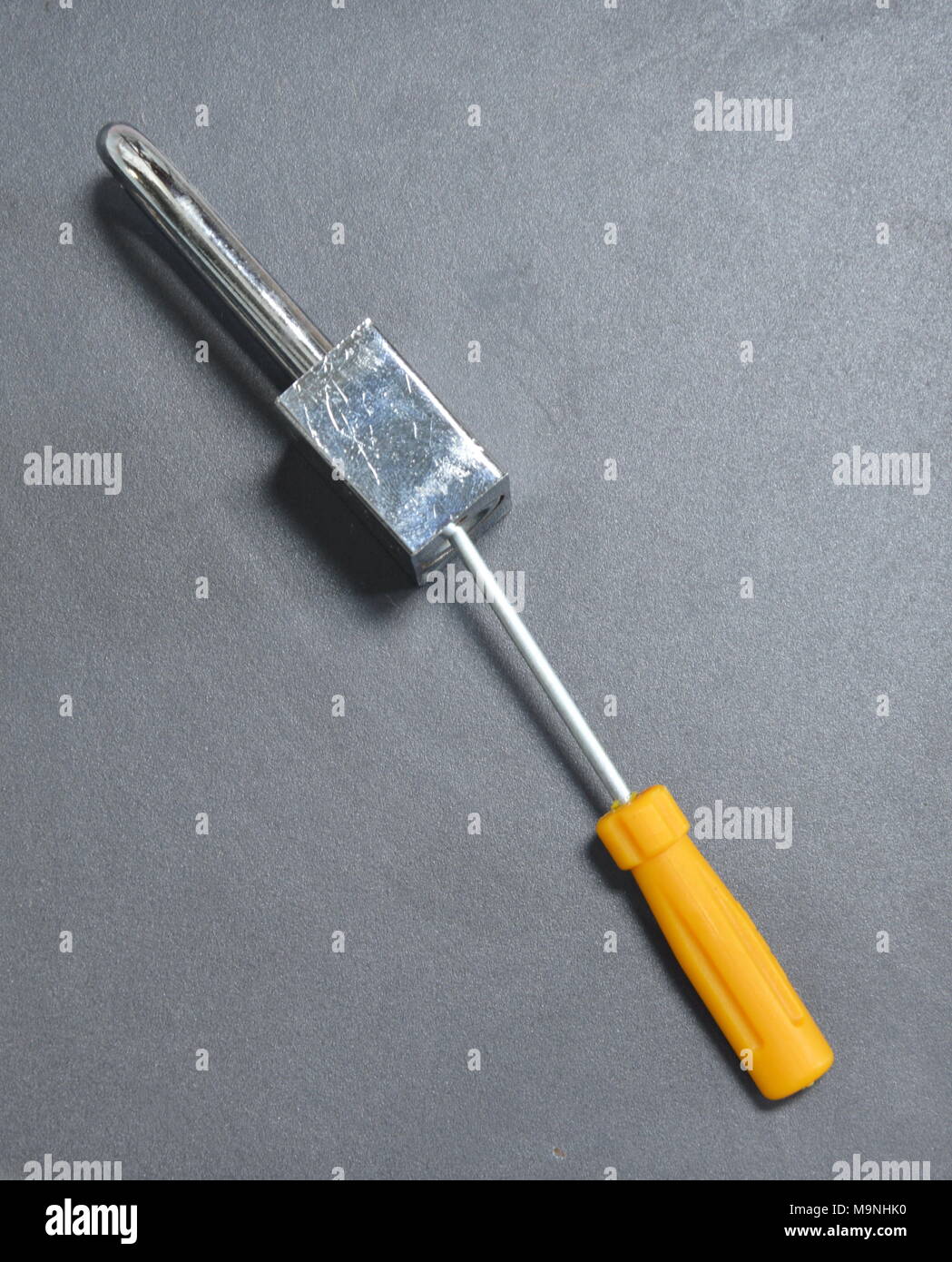 screw stabbing in master key hole on wooden board Stock Photo - Alamy