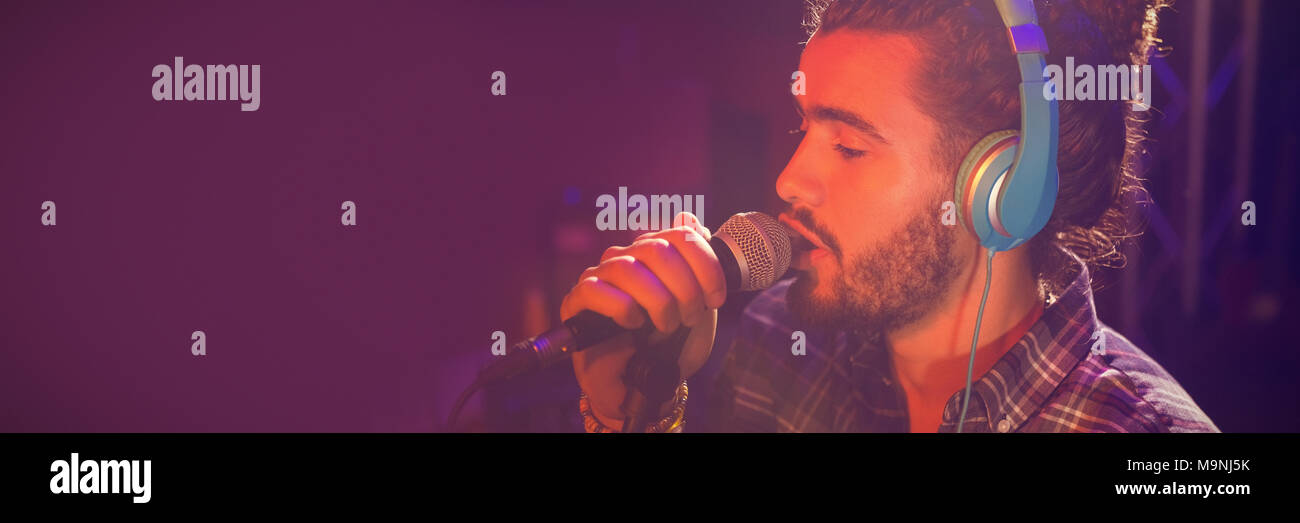 Man singing into microphone hi-res stock photography and images - Alamy