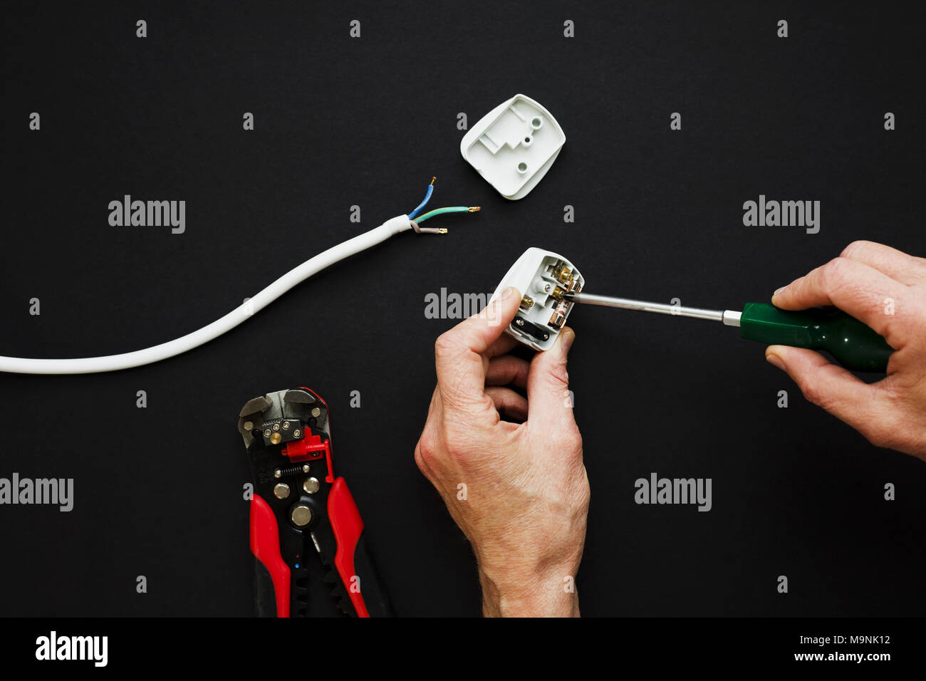 Electrical plug opened up, and is screwing open screw Stock Photo - Alamy