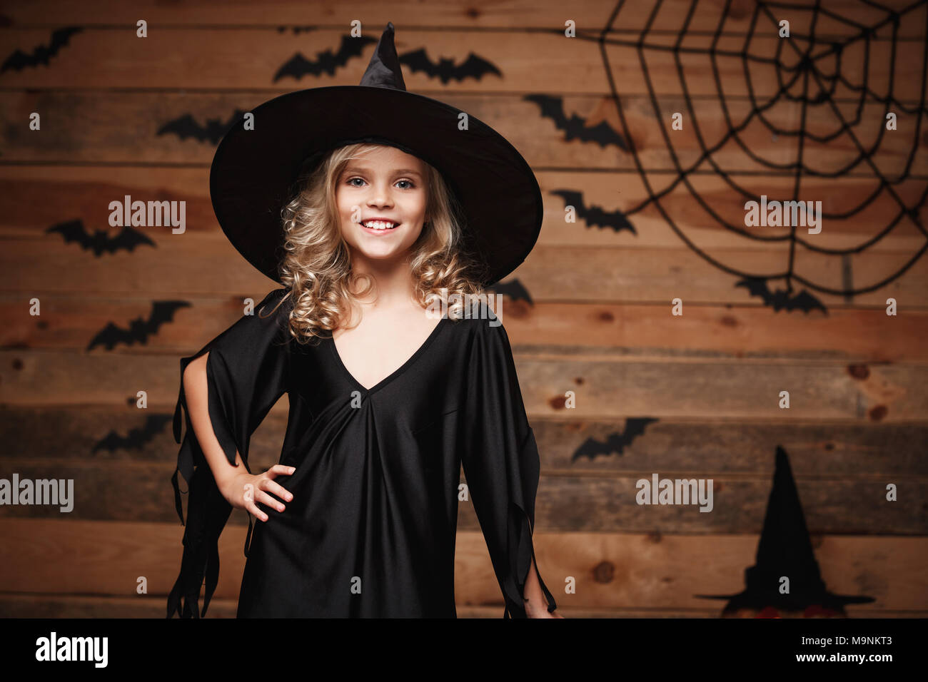 Halloween Witch concept - closeup shot of little caucasian happy witch ...