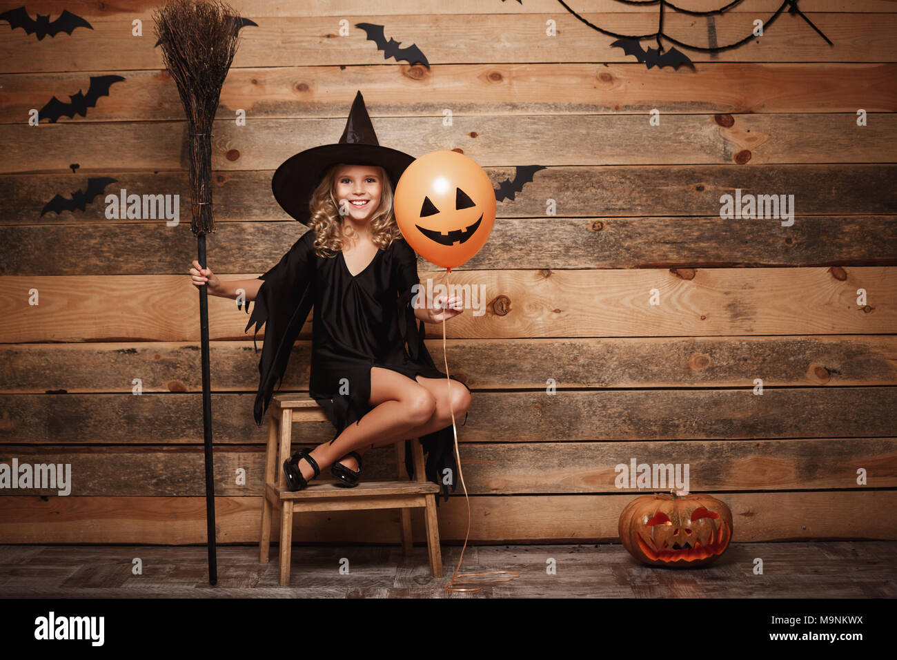 Halloween Witch concept - Full-length shot of little caucasian witch ...