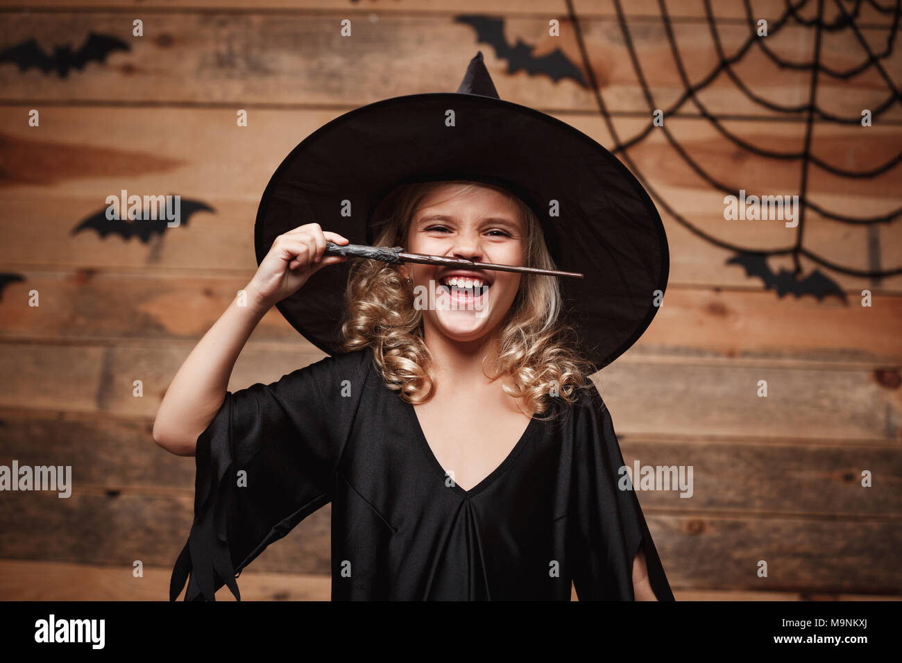 Halloween Witch concept - little witch child enjoy playing with magic ...