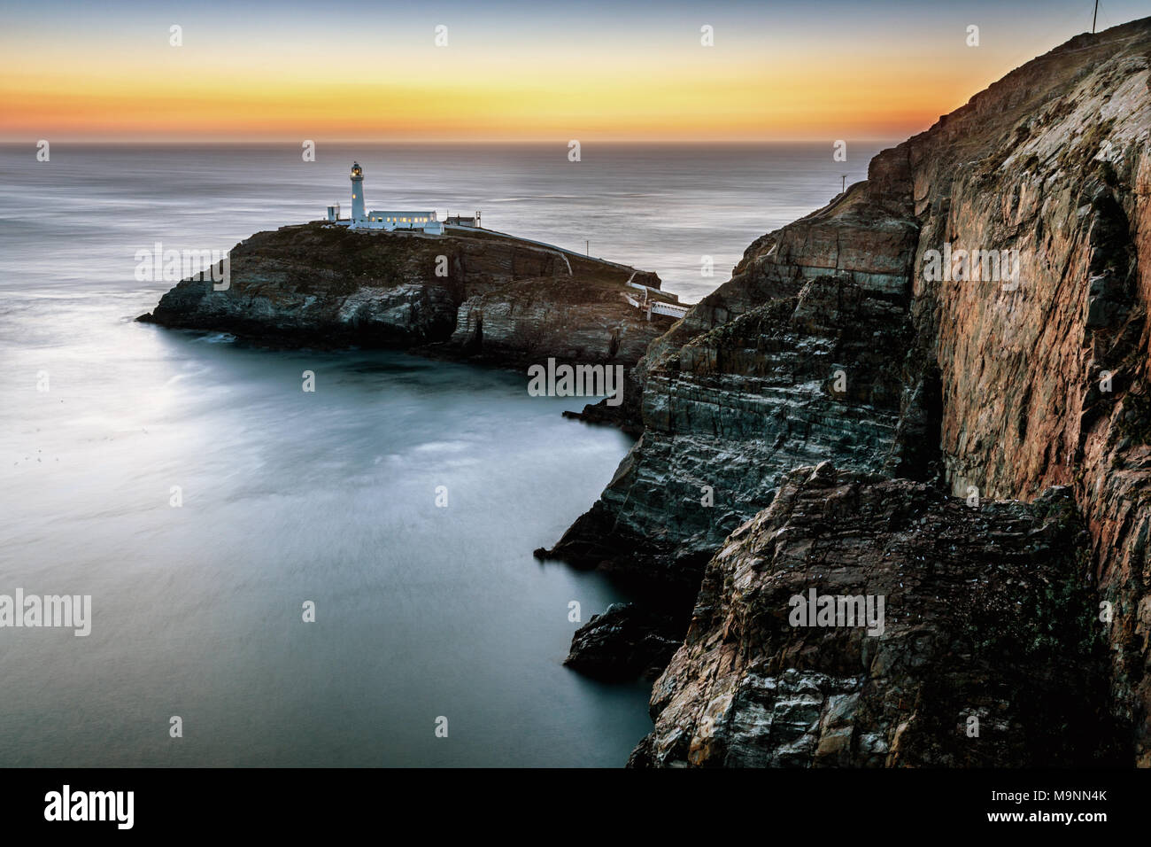 Sunset over South Stack lighthouse, Anglesey, North Wales, UK Stock ...