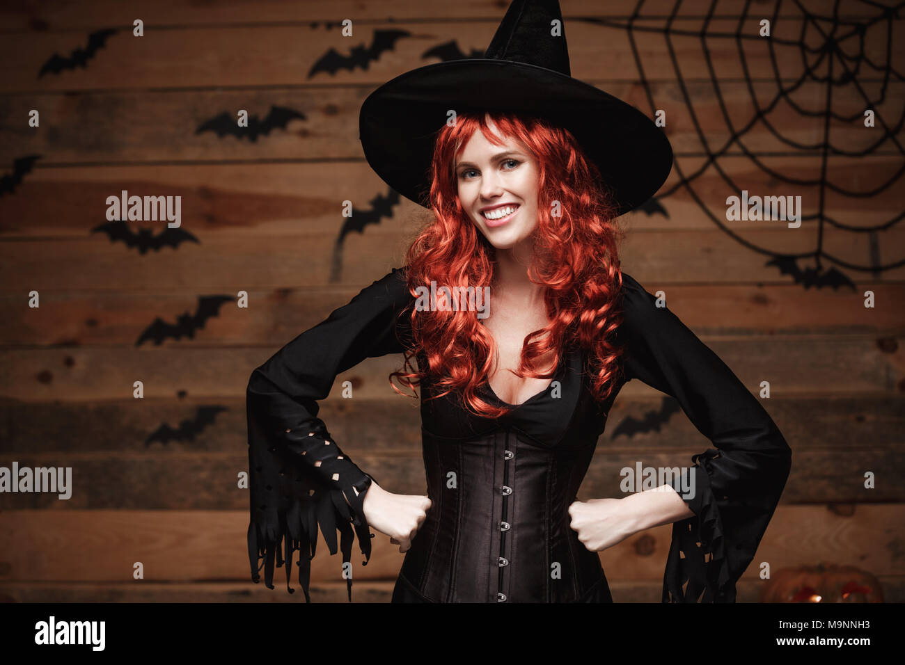 Halloween witch concept - Happy Halloween red hair Witch holding posing ...