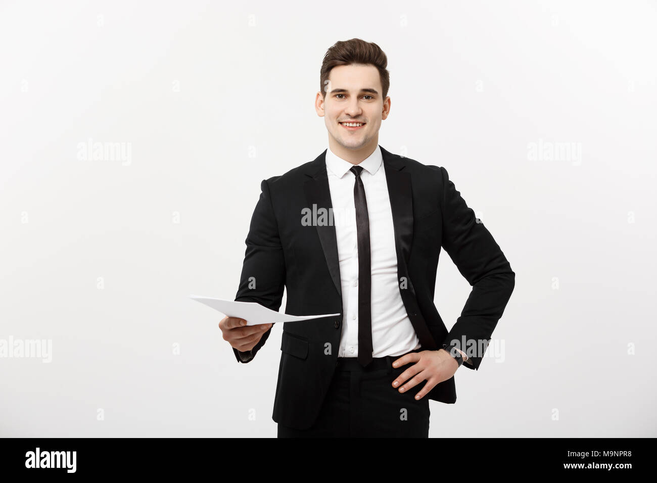 Business and Job Concept: Elegant man in the suit holding resume for ...