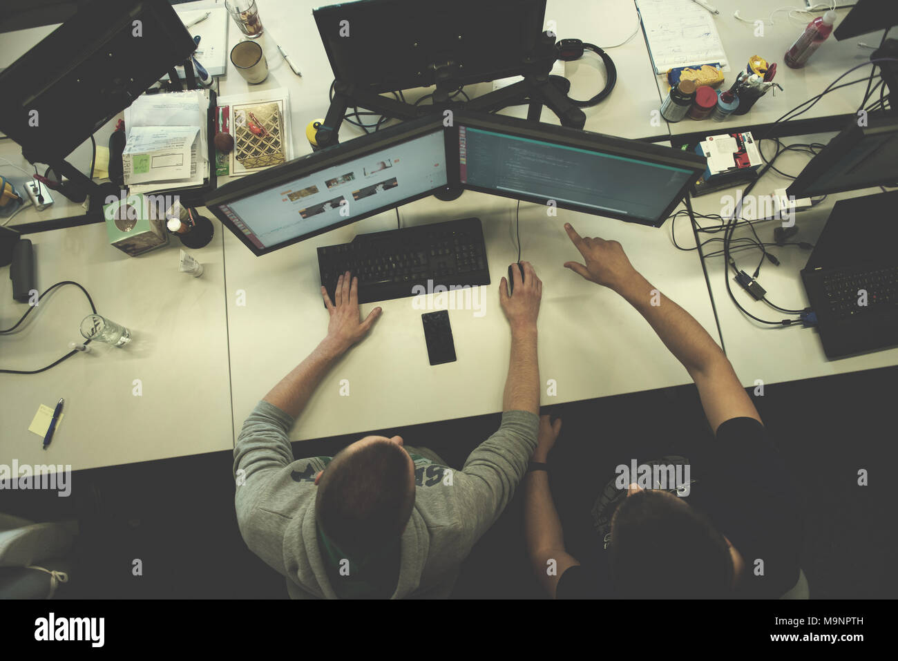 top view of software developers writing programming code on computer ...