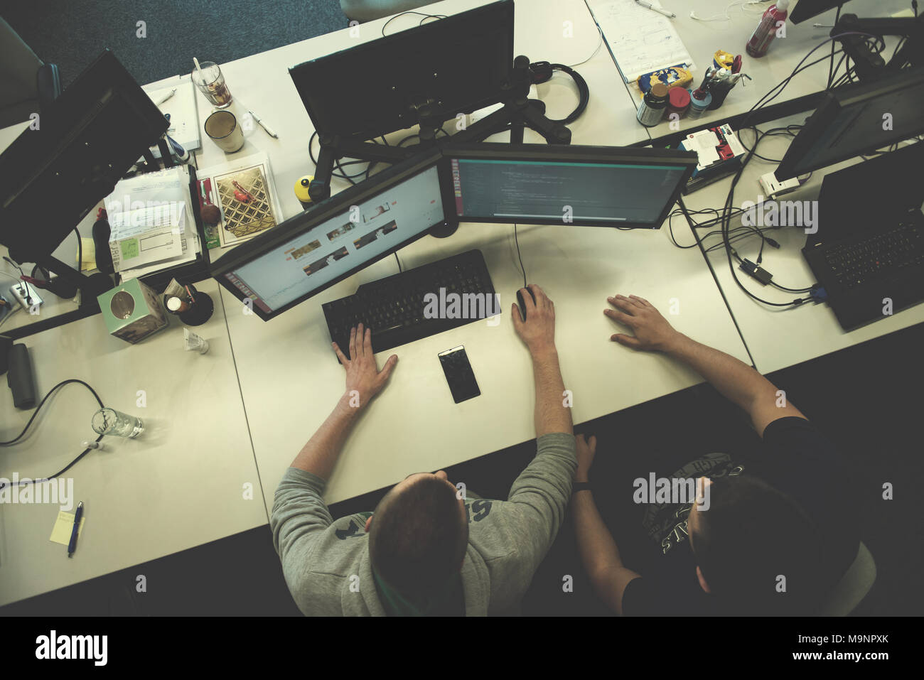 Top View Of Software Developers Writing Programming Code On Computer
