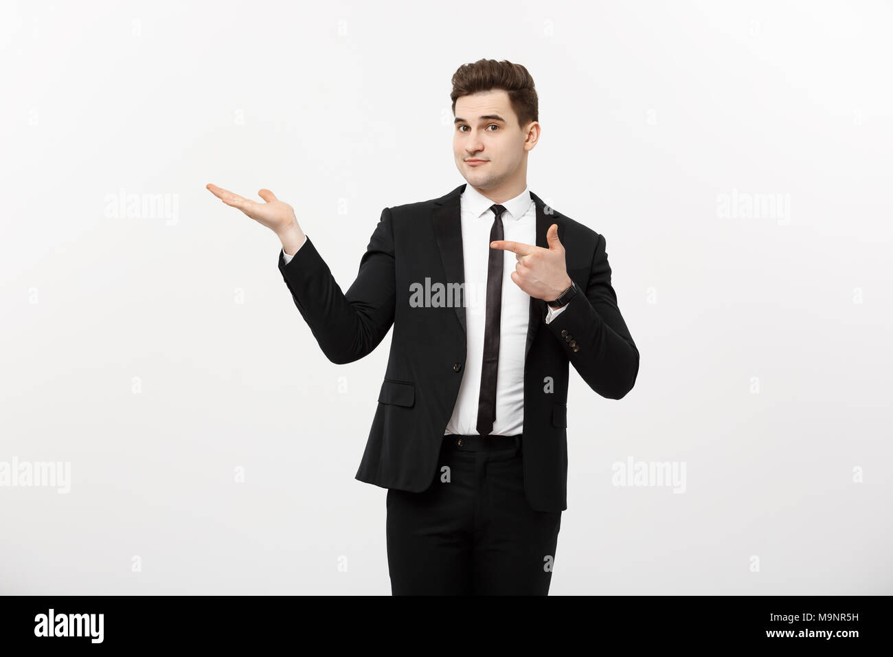 Business Concept: Attractive handsome business man shows hand on side ...