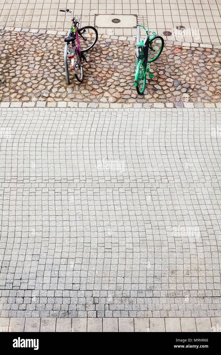 Two bikes parked on cobblestone street pavement, seen from above Stock ...
