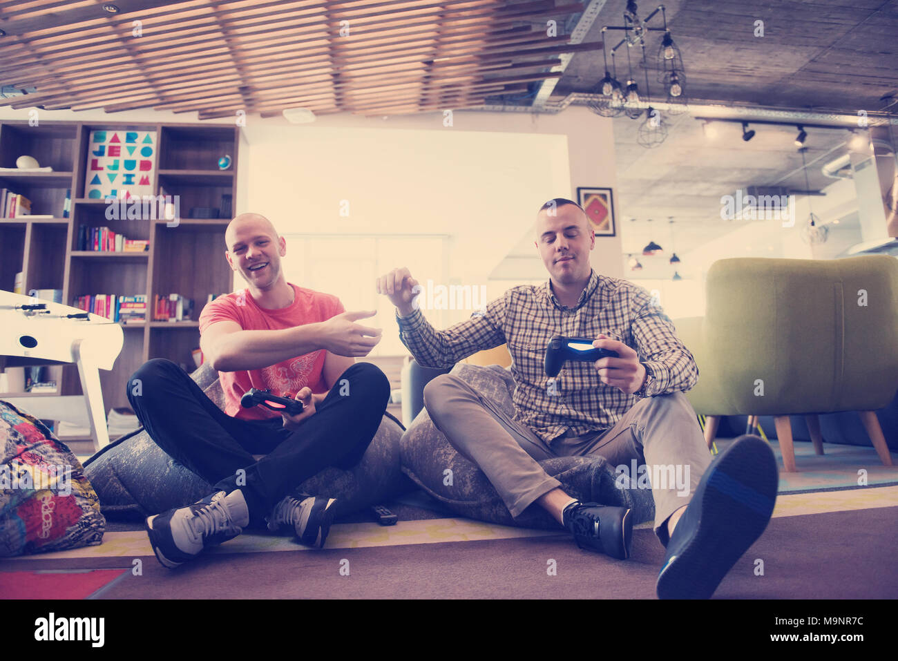 Work hard play hard. Workers Playing computer games in creative startup ...