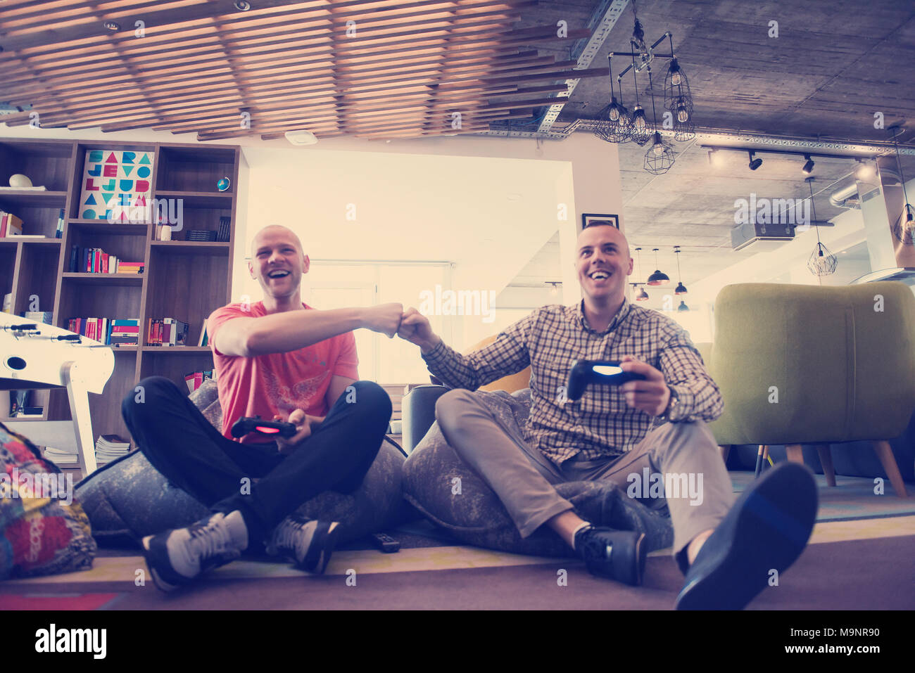 Work hard play hard. Workers Playing computer games in creative startup ...