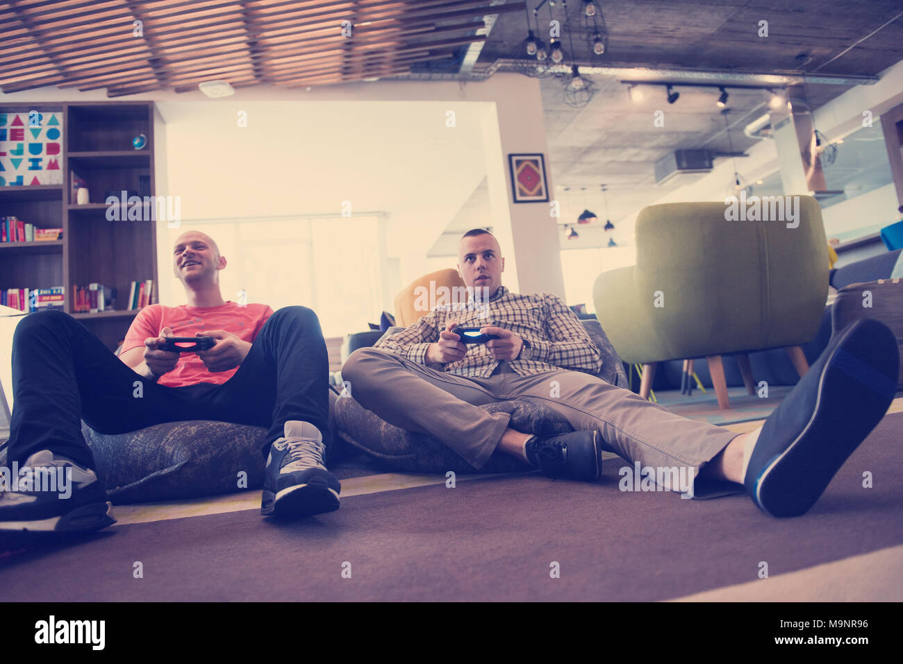 Work hard play hard. Workers Playing computer games in creative startup ...