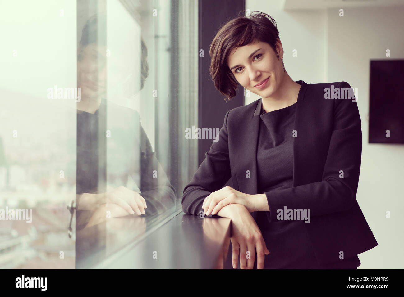 Portrait Of Successful Businesswoman by the window Entrepreneur At Busy ...