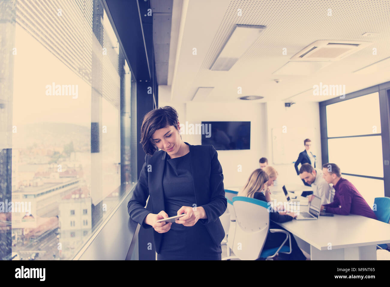 female manager using cell telephone in office interior Stock Photo - Alamy