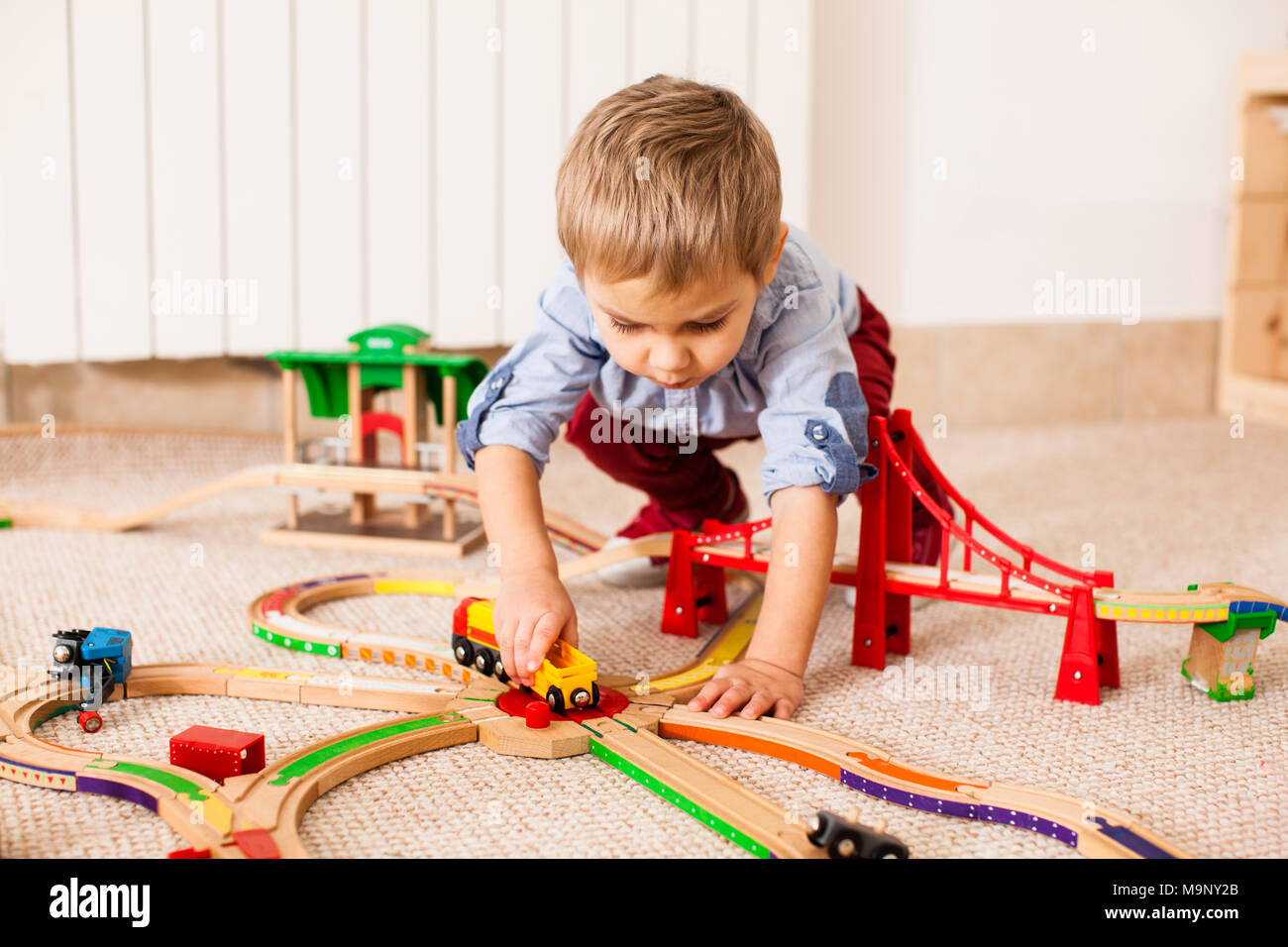 Boy plays with train Stock Photo - Alamy