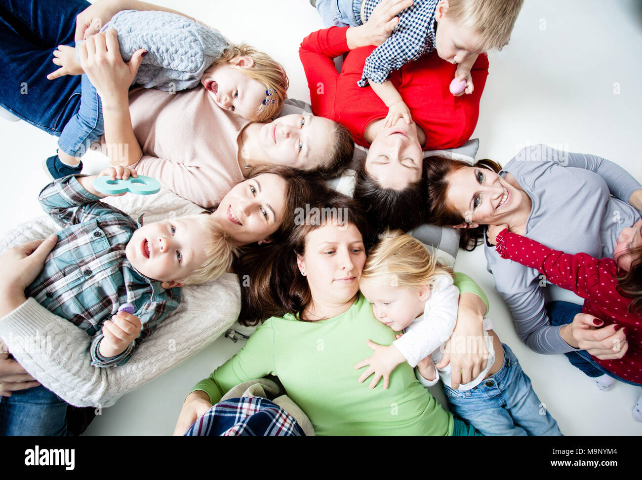 The children with moms Stock Photo - Alamy