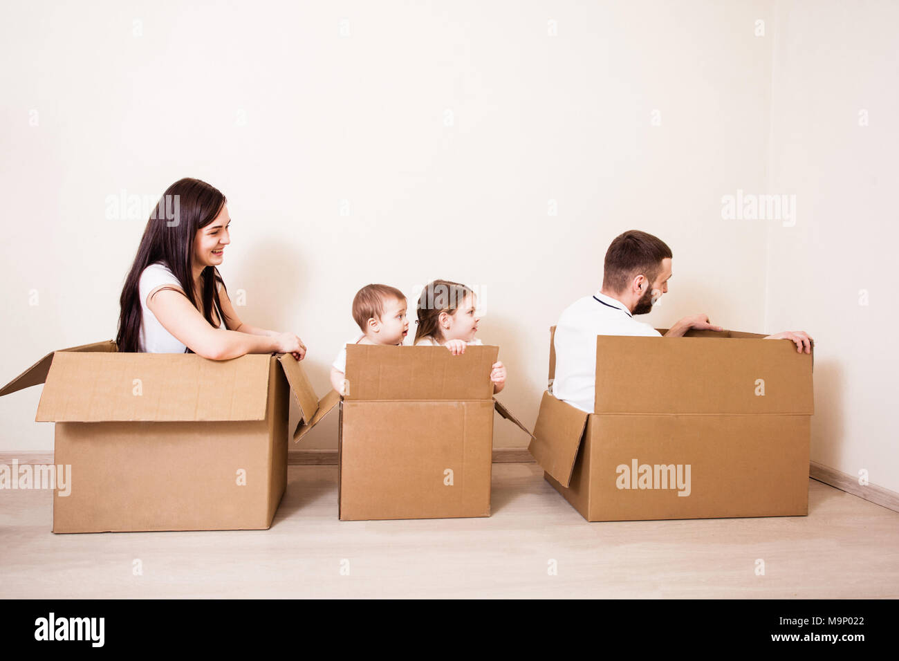 Happy family move Stock Photo - Alamy