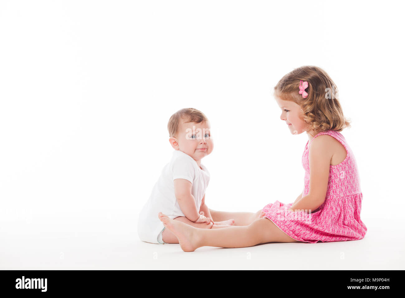 Two sisters isolated Stock Photo - Alamy