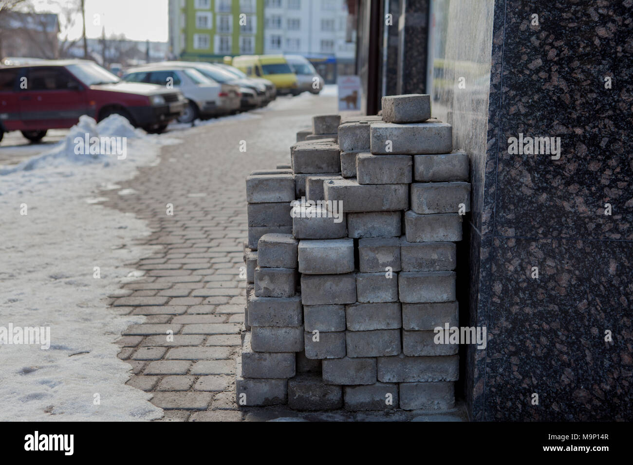 piled up bricks on a newly paved parking area Stock Photo - Alamy