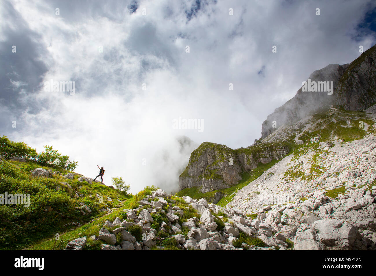 Park ranger of Triglav National Park pointing at Krn mountain, Slovenia ...
