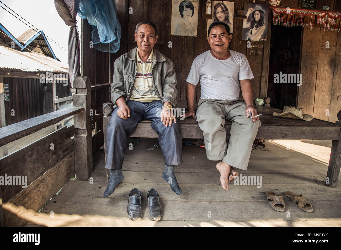 Two locals are sitting in their hut, Preah Meas, Sen Monorom ...