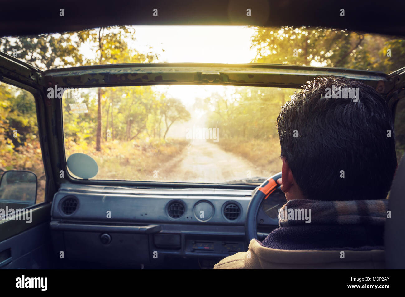 a car with an open top. SUV drivers is a mountain area, photo behind ...