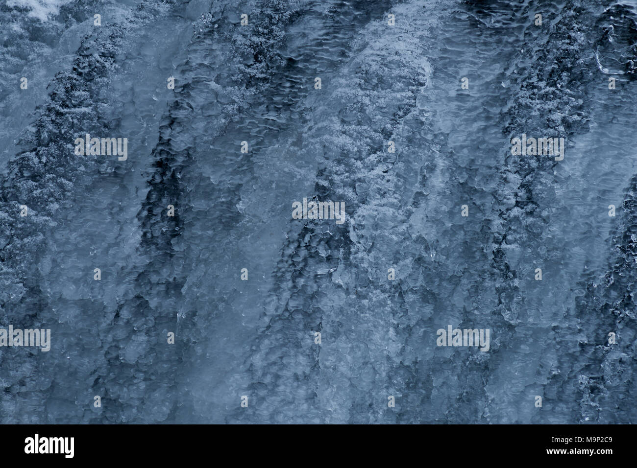 Rapidly flowing cold water through the ice Stock Photo - Alamy