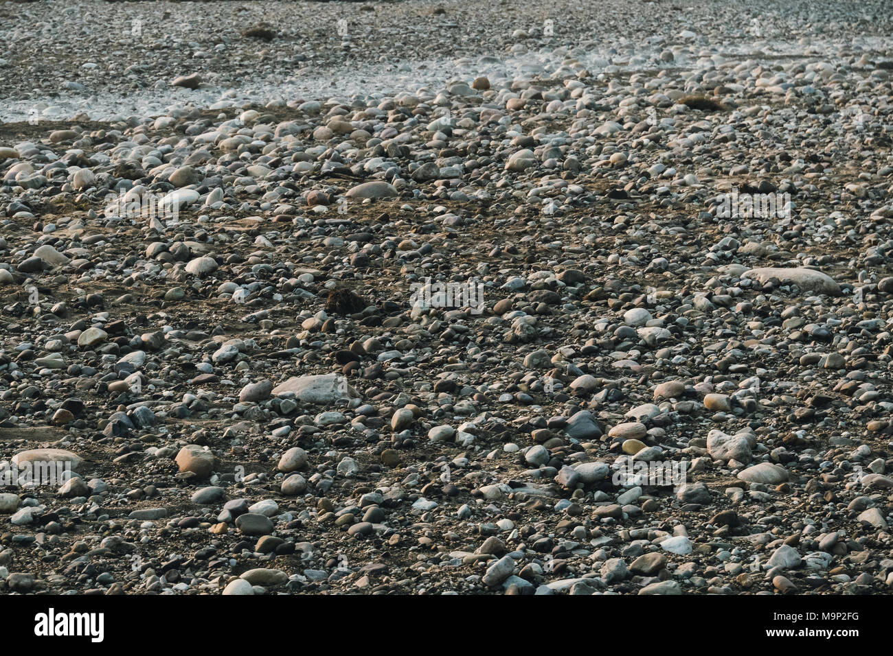 Rocky dry river bed. Mountain side water way. Track through river bed ...