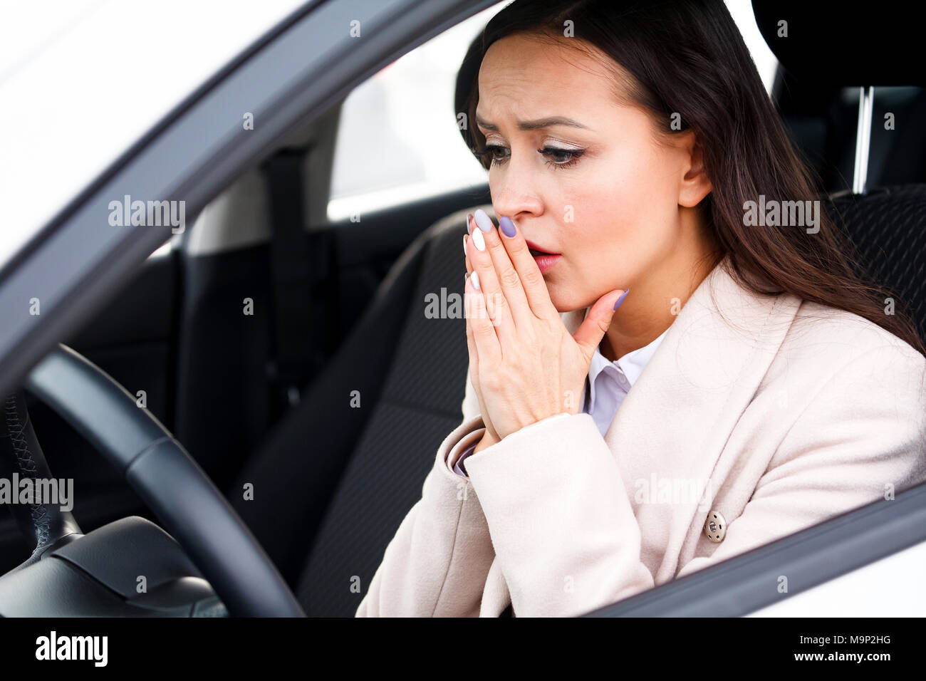 Closeup shot of stressed young woman driver in a car Stock Photo - Alamy