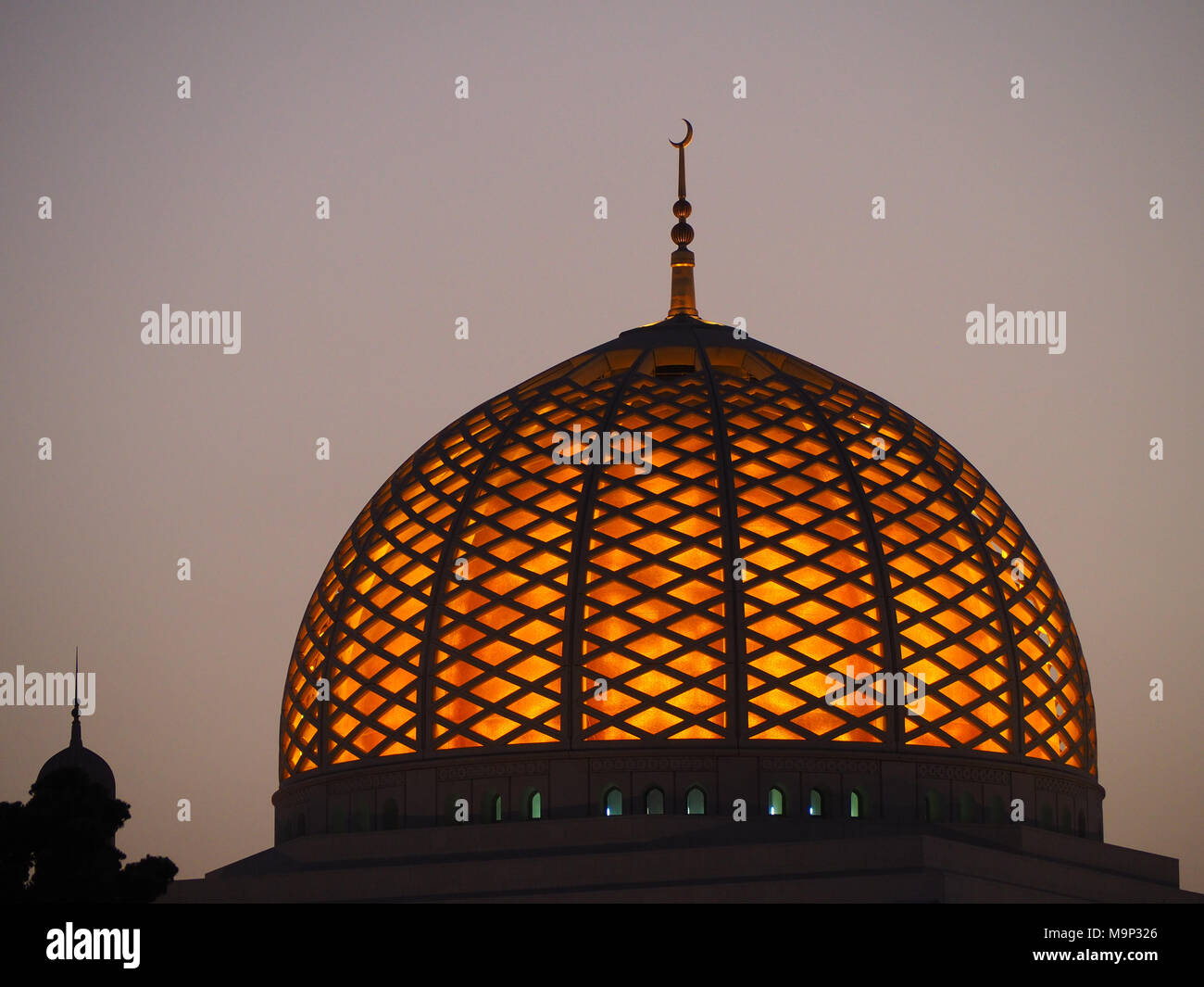 Evening atmosphere, illuminated dome of the Great Sultan Qabus Mosque ...