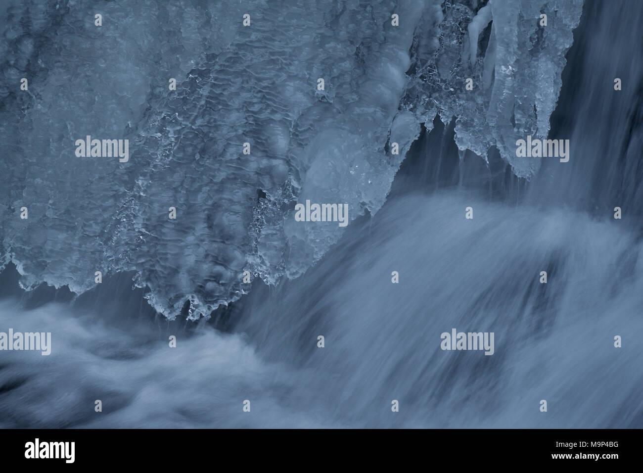 Rapidly flowing cold water through the ice Stock Photo - Alamy
