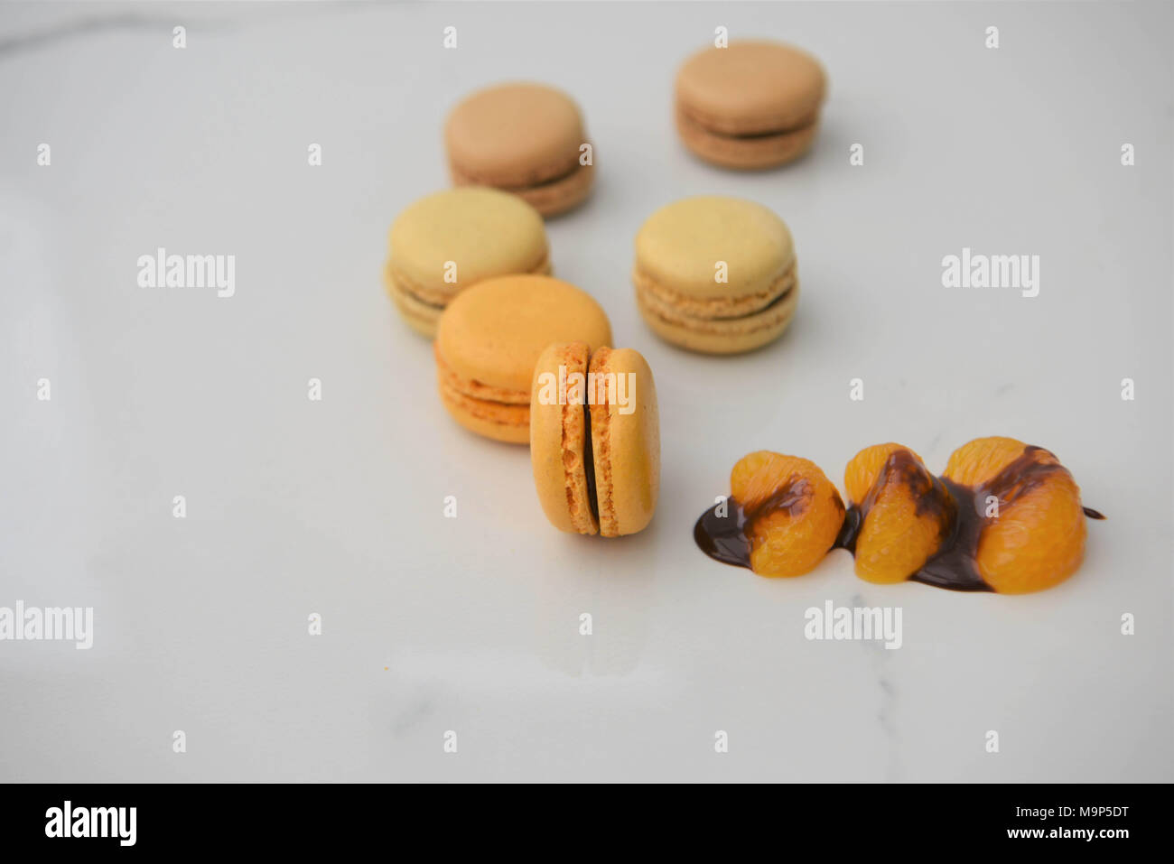 chocolate and orange flavor macaroon biscuits on white marble Stock ...