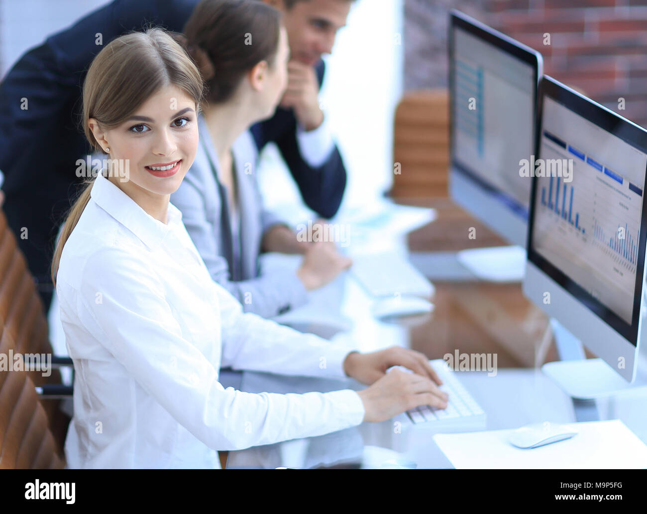 young employee sitting at a Desk Stock Photo - Alamy