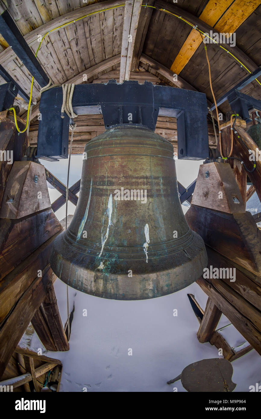 Indoor view of huge metallic bell, inside of stave Church of Lomen ...