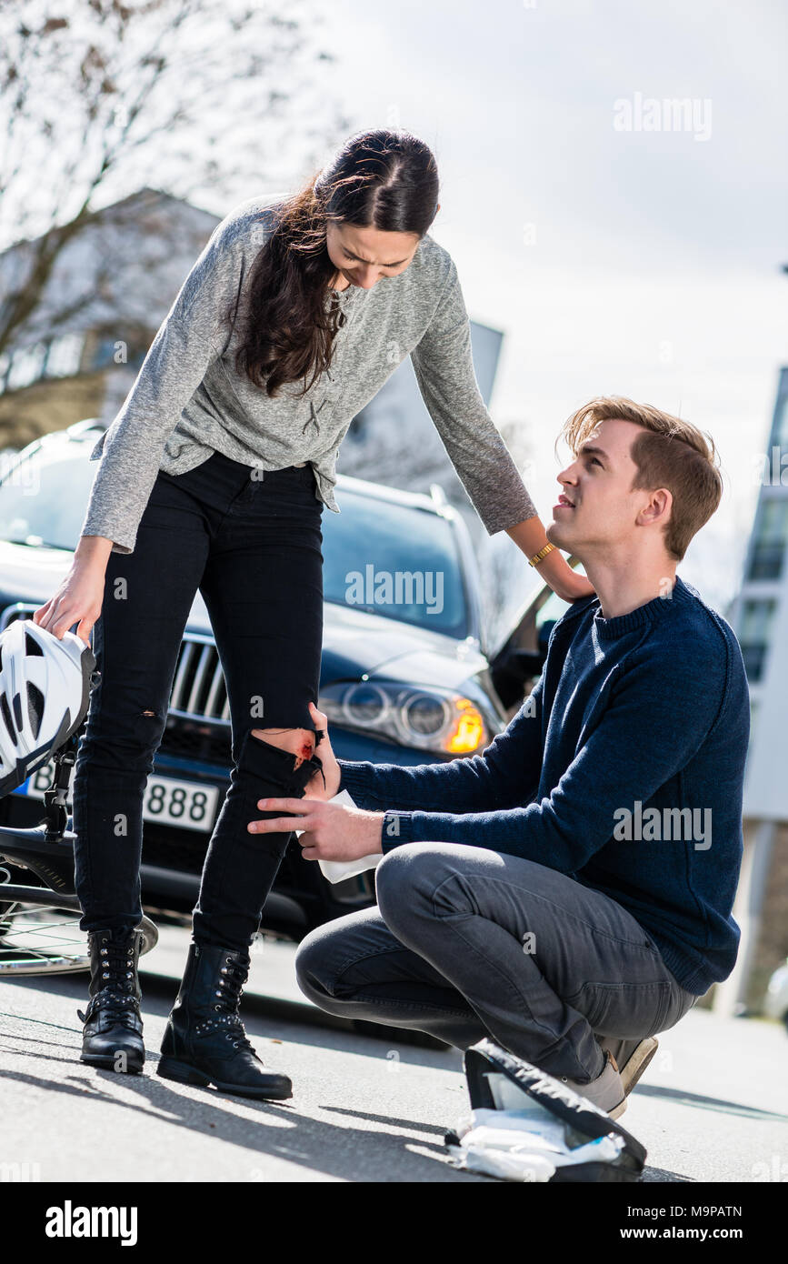 Young driver using a sterile bandage from his first aid kit Stock Photo ...